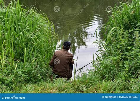 De Visser Zit In Het Riet En Vangt Vis Stock Afbeelding Image Of