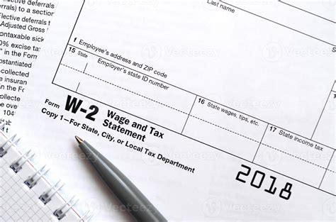 The Pen And Notebook On The Tax Form W 2 Wage And Tax Statement The