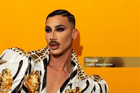 Portrait Of Beautiful Drag Queen Model With Yellow Background Stock