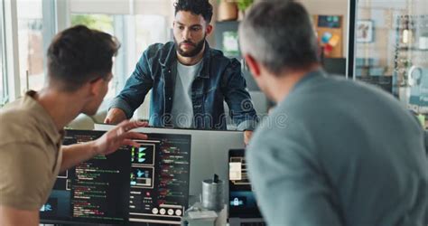 coding computer screen and discussion with business people in office together from back