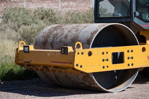 Close Up Shot Of Vibrating Soil Compacting Roller Machine At Work Stock