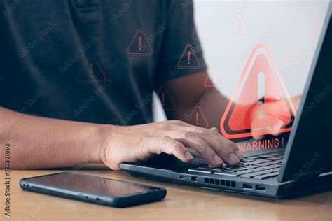 User Uses Laptop With Warning Triangle Sign For Error Notification And Maintenance Concept