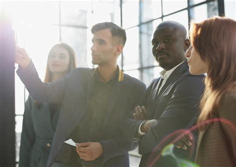 Premium Photo Creative Business Team Looking At Sticky Notes On Glass