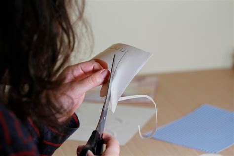 Premium Photo Close Up Of Woman Cutting Paper