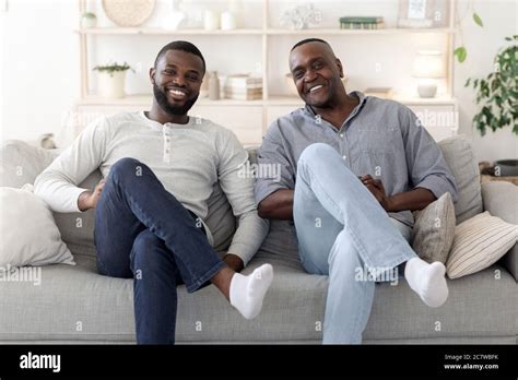 Like Father Like Son Happy Man Sitting In Similar Pose With Dad Stock