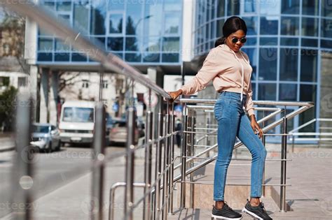 Hipster African American Girl Wearing Pink Hoodiesunglasses And Jeans
