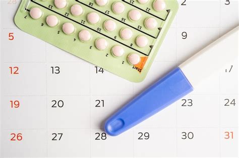 Premium Photo Pregnancy Test And Birth Control Pills On Calendar Contraception Health And Medicine