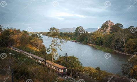 Aerial View Of A Train Wagons Passing By The River Surrounded By