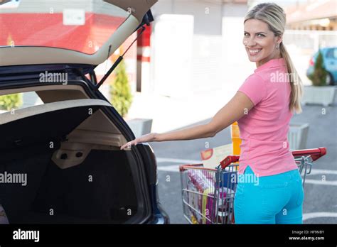 Customer Woman Loading Car With Food At Supermarket Car Park Stock