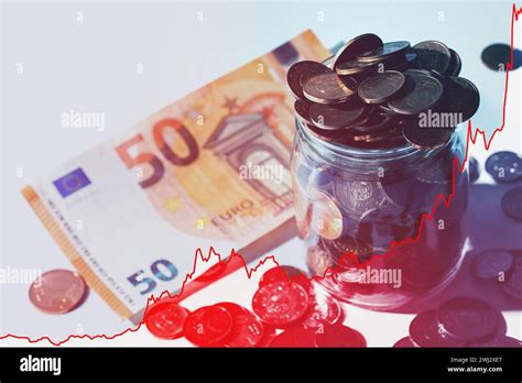 Glass Jar Full Of Shiny Euro Coins And Rising Sparkline Chart Stock