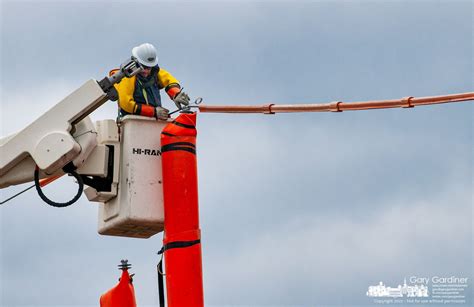 Switching Power An Electrician Wrapped In Protective Gear Ties Off A