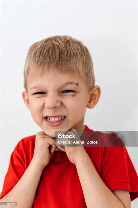 Vertical Photo Of A Boy Who Is Angry He Has A Scratch On His Face And