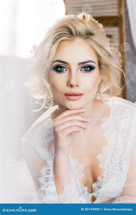 Portrait Of A Blond Girl In A Negligee With A Beautiful Hairdo A Stock