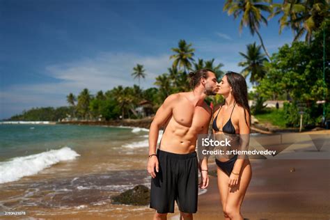 Romantic Couple Kissing On Tropical Beach Man And Woman In Swimwear