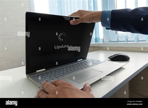 Updating Software Technology Upgrade Concept A Businessman Opens A Modern Ultrabook On Which Updating Software Technology Upgrade Concept A Businessman Opens A Modern Ultrabook On Which