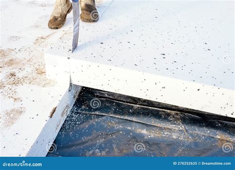 Builder Placing Polystyrene Insulation Boards On Waterproofing Membrane