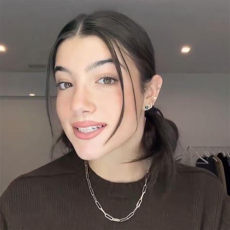 Woman Taking Selfie In Brown Shirt And Silver Necklace