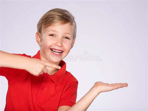 Portrait Of Cheerful Boy Pointing To The Right Isolated Over White