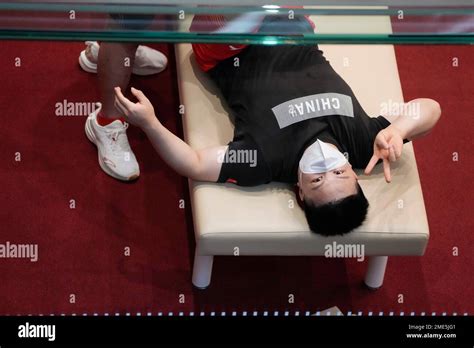 Shi Zhiyong Of China Victory Sign As Is Stretched By A Team Athletic
