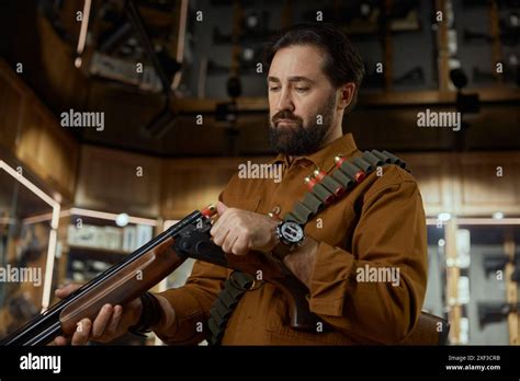 Man Loading Bullet Into The Rifle At Legal Commercial Weapon Store For