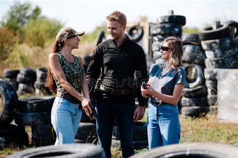 A Weapons Instructor Teaches A Girls To Shoot A Pistol At A Firing