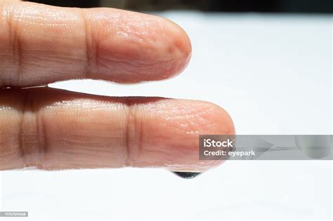 Womans Wet Left Hand With Water Drops On Middle Finger White Acrylic