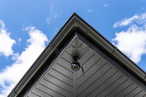 Round Wireless Camera Mounted On The Corner Of The Roof In The Soffit Monitoring Of A Single