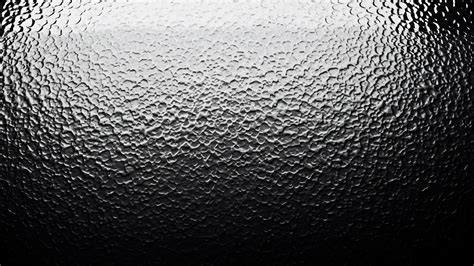 Dynamic Close Up Of A Dark Textured Metallic Surface With Reflective
