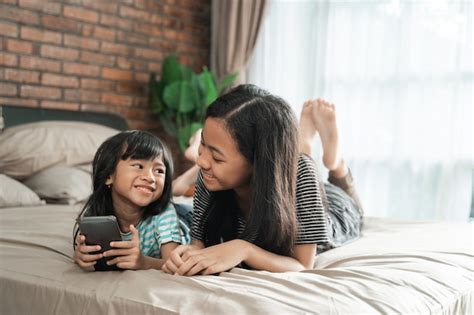 Premium Photo Cute Sibling Using Mobile Phone Together