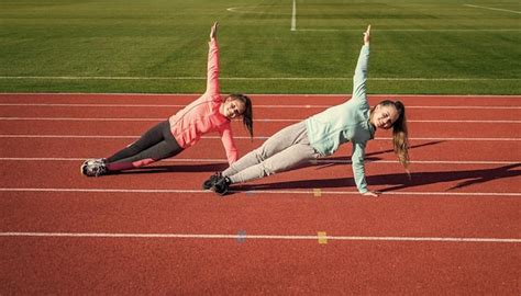 Premium Photo Towards The Healthier Lifestyle Teenage Girls Standing In Side Plank Athletes