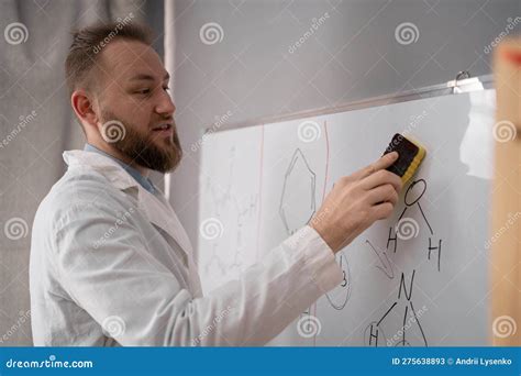Teacher Cleaning The Whiteboard Holding Eraser Erasing In Classroom Stock Image Image Of
