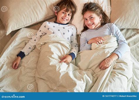 Brother And Sister Are Lying In Bed Stock Image Image Of Sister