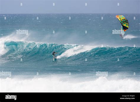 A Kitesurfer Rides The Waves In Front Of The Hoʻokipa Beach On The