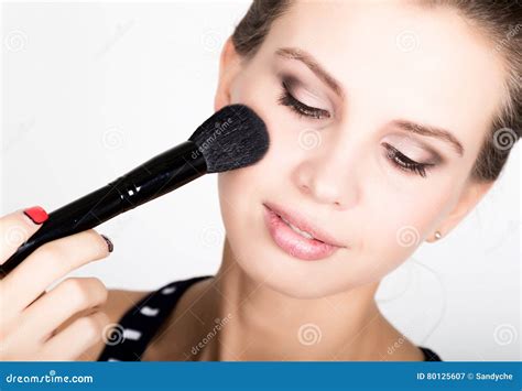 Female Model Applying Makeup On Her Face Beautiful Young Woman