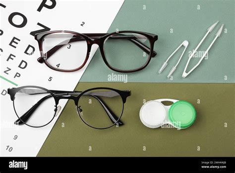 Vision Test Chart Glasses Lenses And Tweezers On Color Background