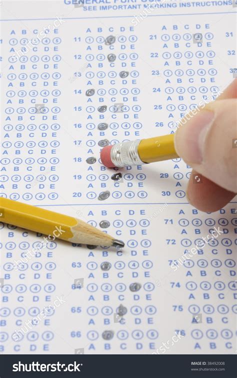 Blue Bubble Test Form Completed For An Exam With A Man Erasing The