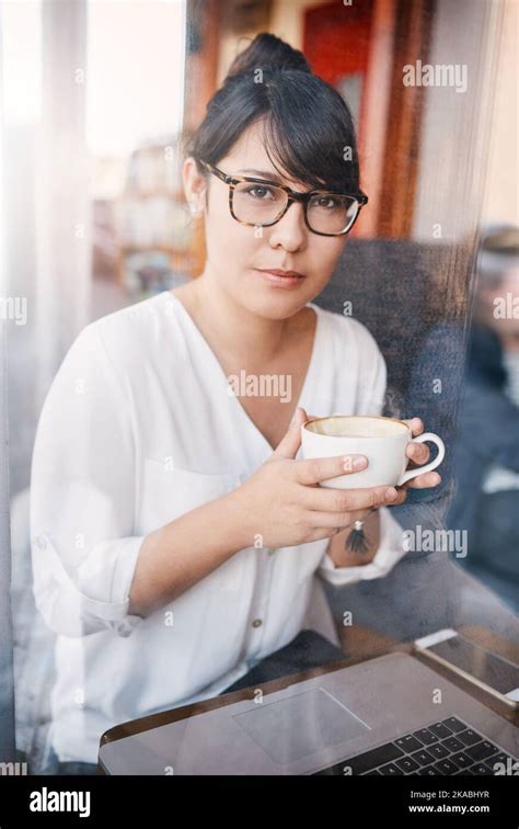 Coffee Keeps Me Going A Beautiful Young Woman Having A Sip Of Her