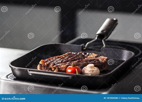 Hot Steak At Griddle Pan Closeup Grill Beef With Tomato And Mushroom