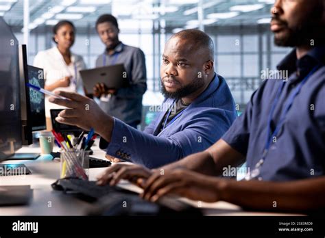 Teamworking Engineers In Data Center Using Diagnostic Tools And System Monitoring Software To