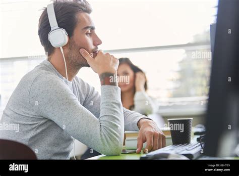 Man With Computer As Programmer Wearing Headphones Stock Photo Alamy