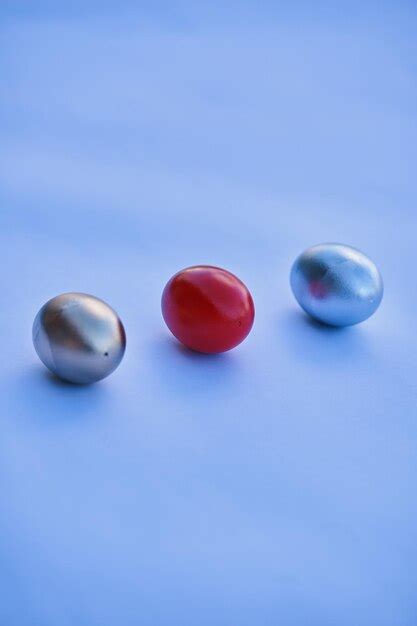 Premium Photo Three Different Colored Balls On A Blue Background