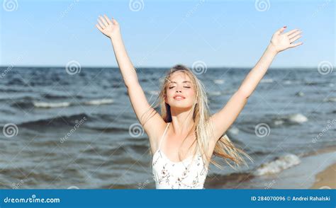 Happy Blonde Beautiful Woman On The Ocean Beach Standing In A White
