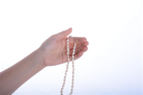 Premium Photo Hand Holding A Necklace