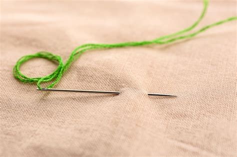 Premium Photo Fabric With Sewing Thread And Needle Closeup