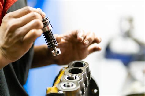 Closeup Photos Of Assembling Engine Parts Or Machines That Have Components That Are Springs By