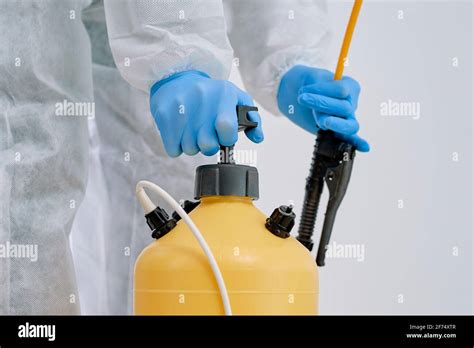 Decontamination Service Worker Using A Container Of Disinfectant Stock