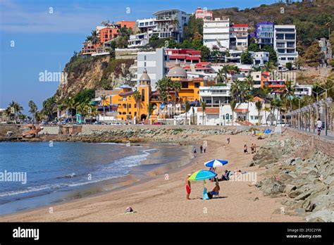 Tourists Sunning On The Beach Along The Malecón Esplanade In The