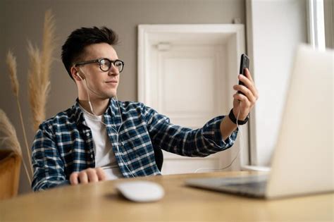 Premium Photo Programmer Takes A Break Listening To Music With Headphones A Man With Glasses