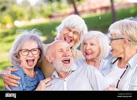 Group Of Happy Elderly People Bonding Outdoors At The Park Old People
