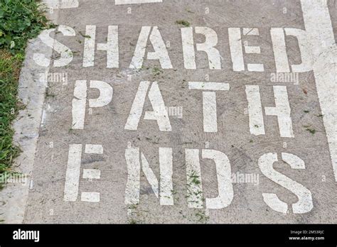 A Close Up Shot Of Shared Path Ends Road Marking On A Path Stock